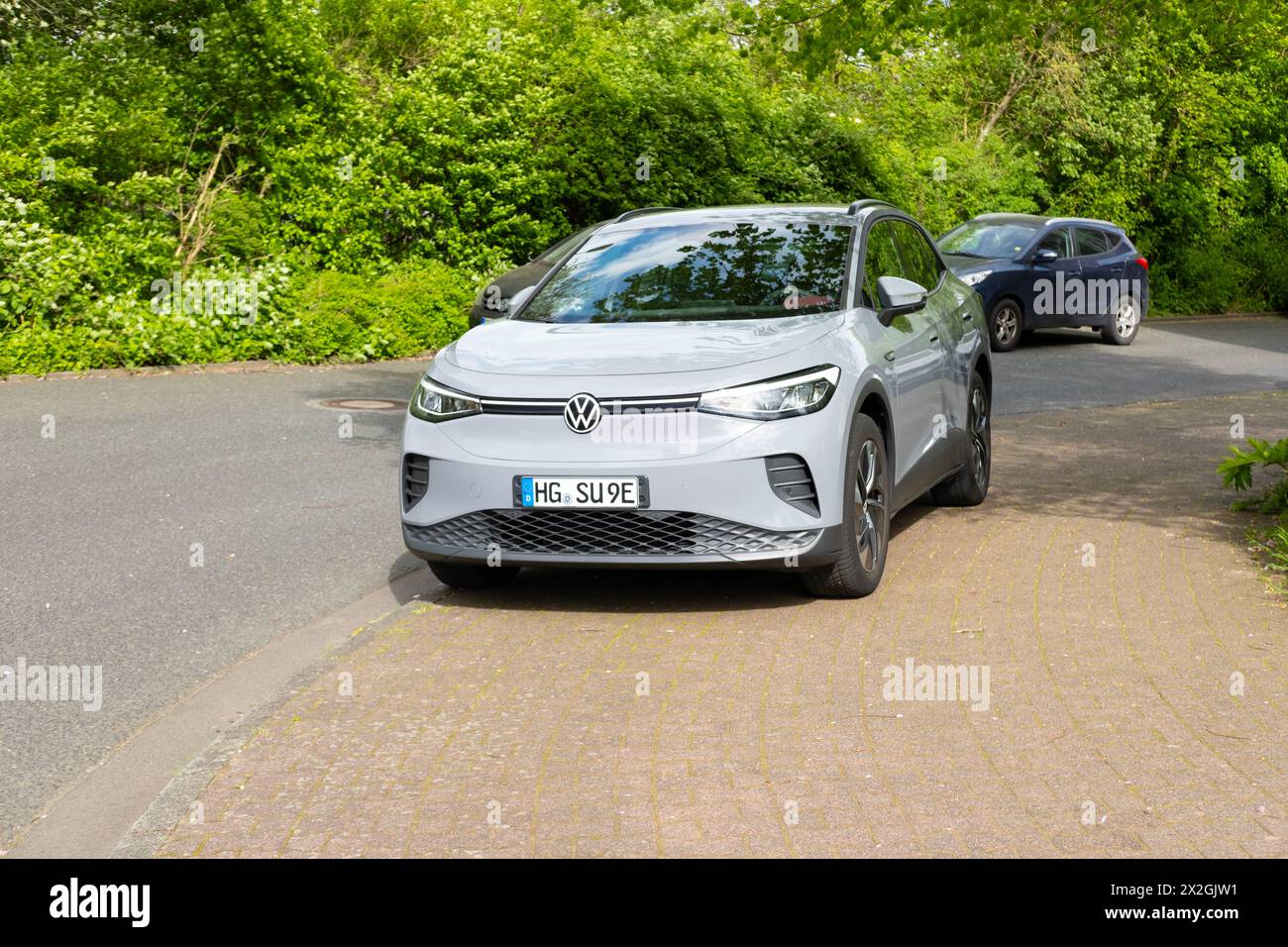 electric light blue car Volkswagen ID.4 on street, technology German ...