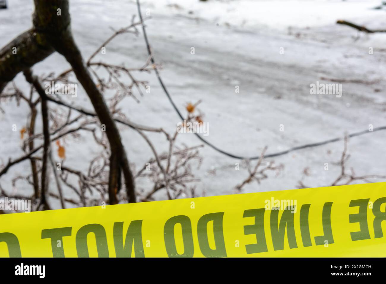Caution yellow tape by fallen electric cable after a storm Stock Photo ...