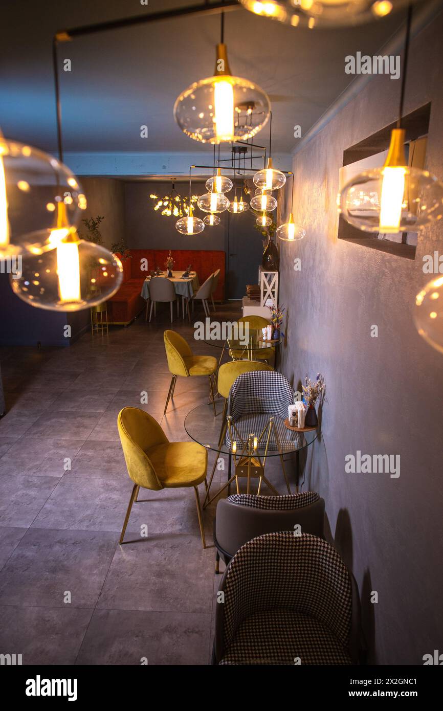 Elegant restaurant with dim lighting, stylish furniture, dark walls ...