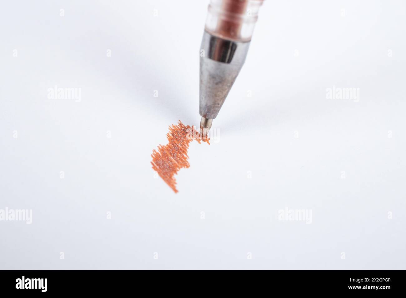 Brown glitter ink ball pen scribbling on white paper, soft focus Stock ...