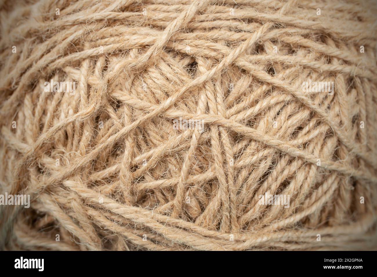 Ball or bundle of jute thread close up soft focus texture, backdrop ...