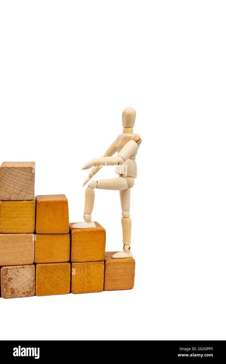 Wooden mannequin climbing on wood blocks stair, isolated on white ...