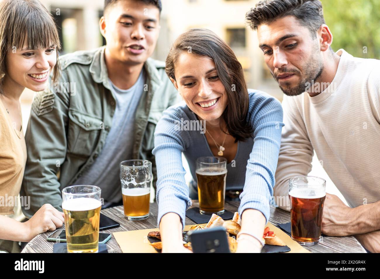 Shared joy over food and drinks. A diverse group of millennials engages ...