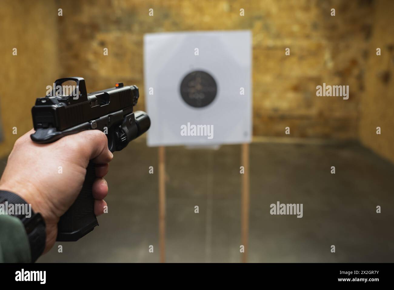 Tactical pistol shooting at a target in a shooting range, first-person ...