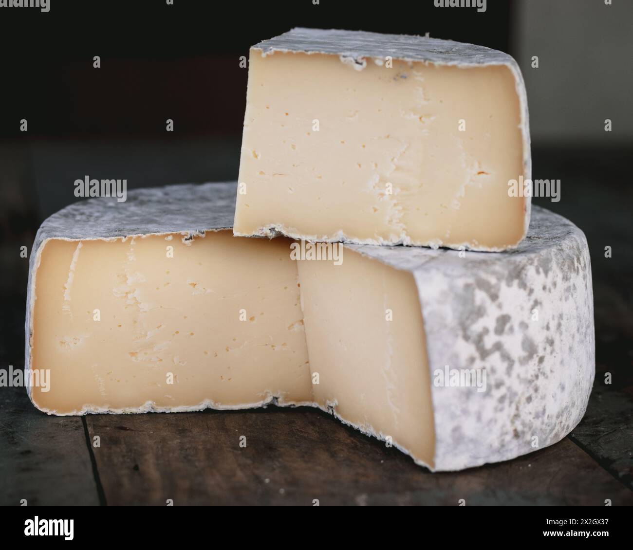 Rustic natural rind cheese wheel on wood board Stock Photo - Alamy