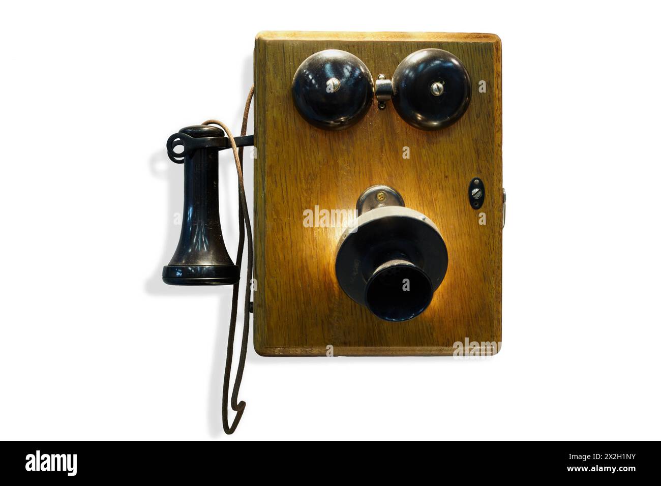Old-fashioned wall-mounted phone with wooden case Stock Photo - Alamy