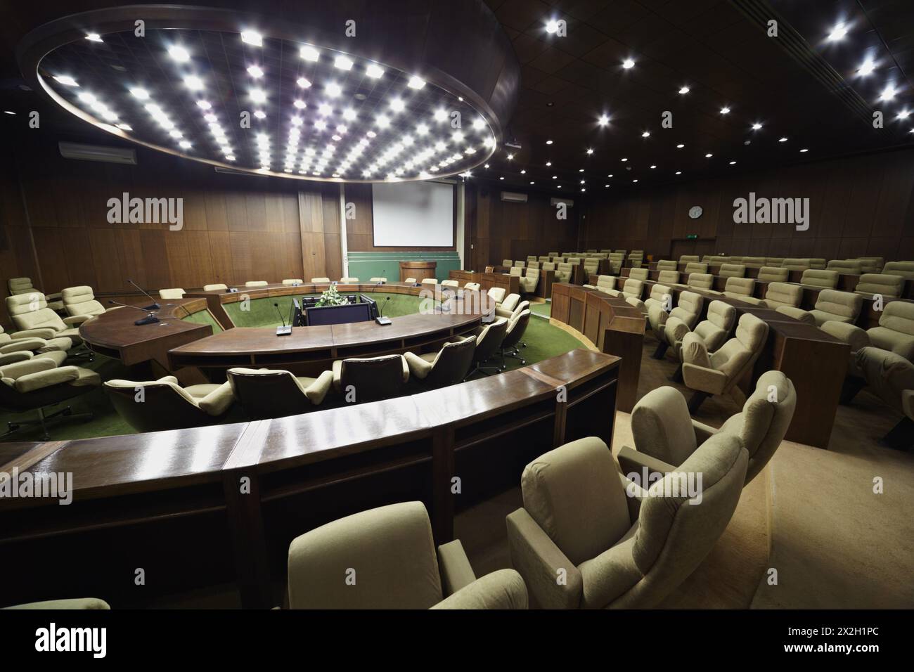 Auditorium for the meeting with round table, rostrum and rows of chairs ...