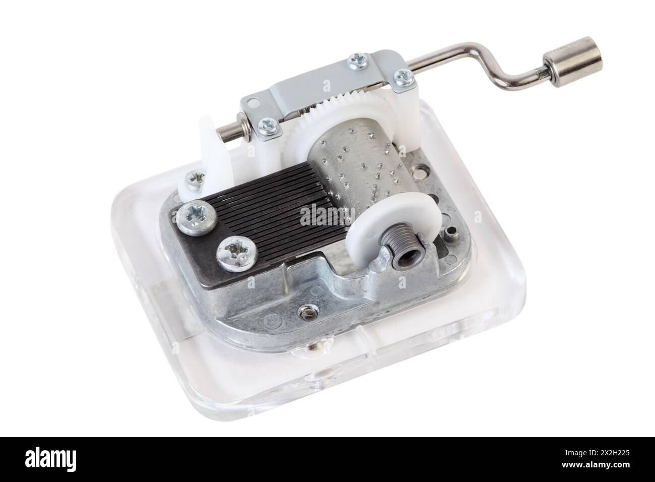 small clockwork toy isolated on white background; mechanism of music ...