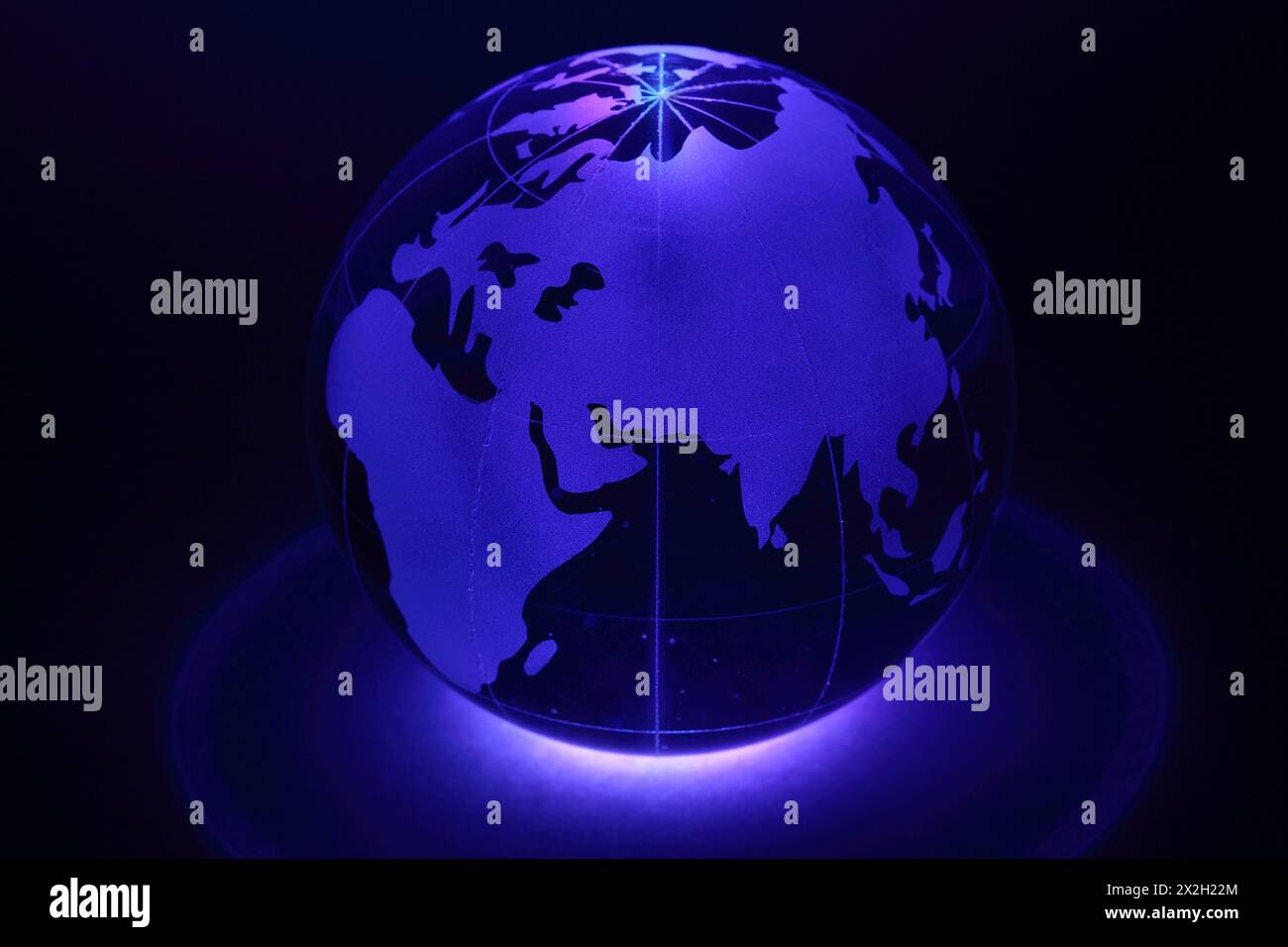 Small glass globe is illuminated by blue light from below; Africa and ...