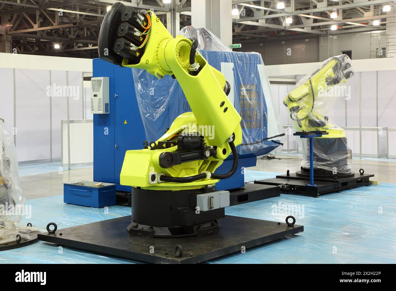 two big new yellow robots for automotive industry at exhibition Stock ...