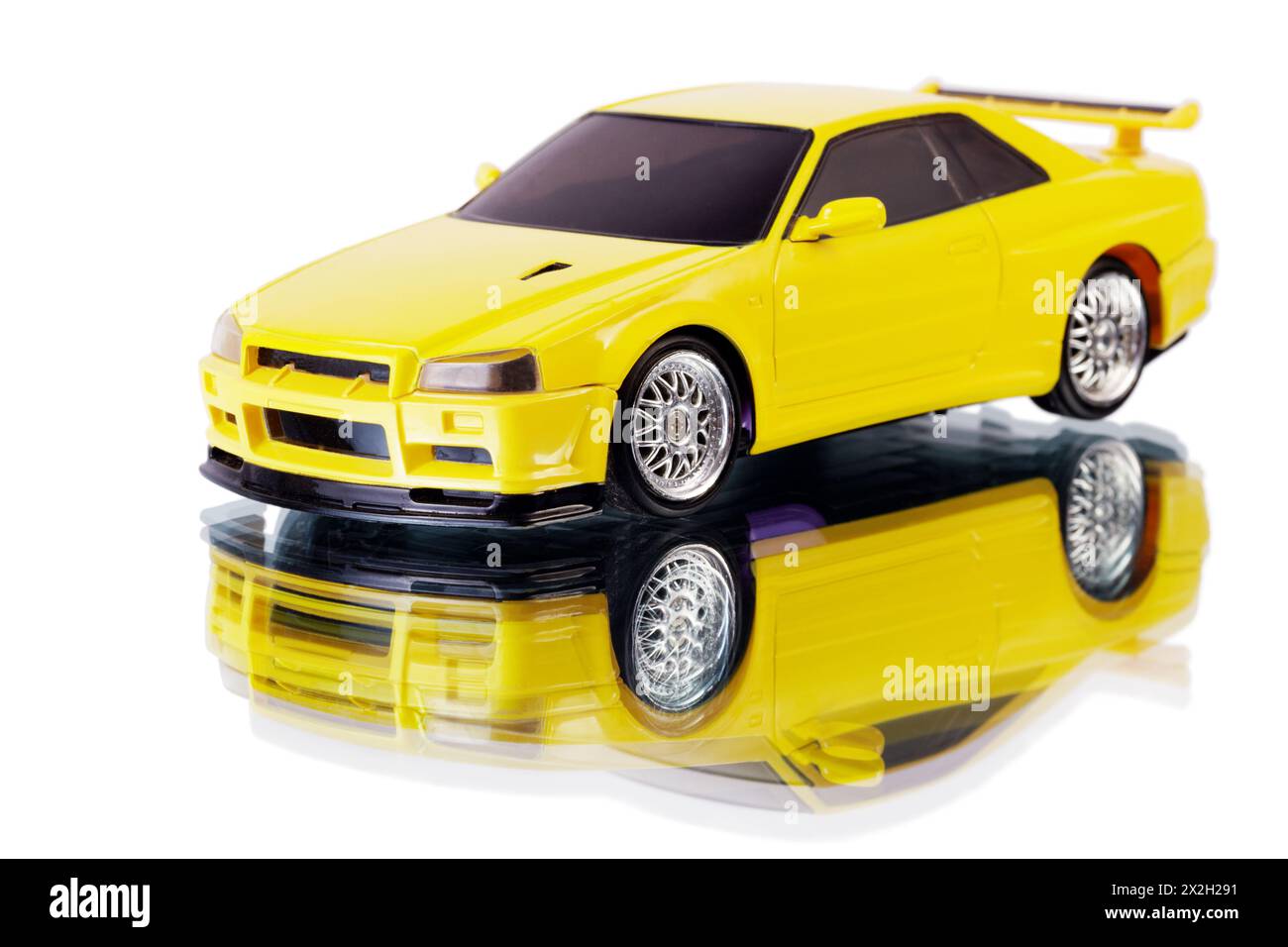 Yellow toy car and its reflection isolated on white Stock Photo - Alamy