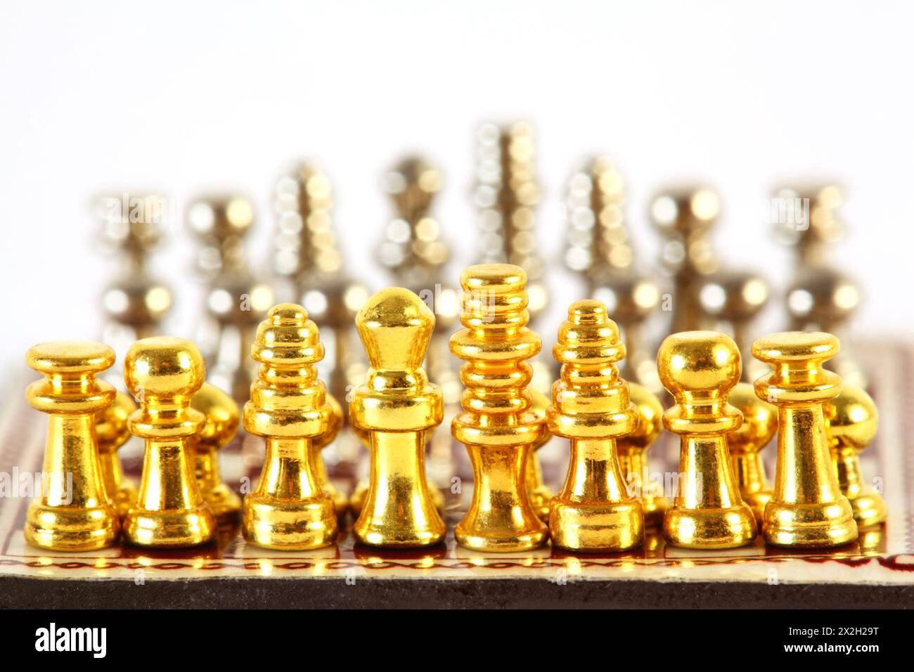 Gold and silver small chess stand on checkerboard; complete set Stock ...