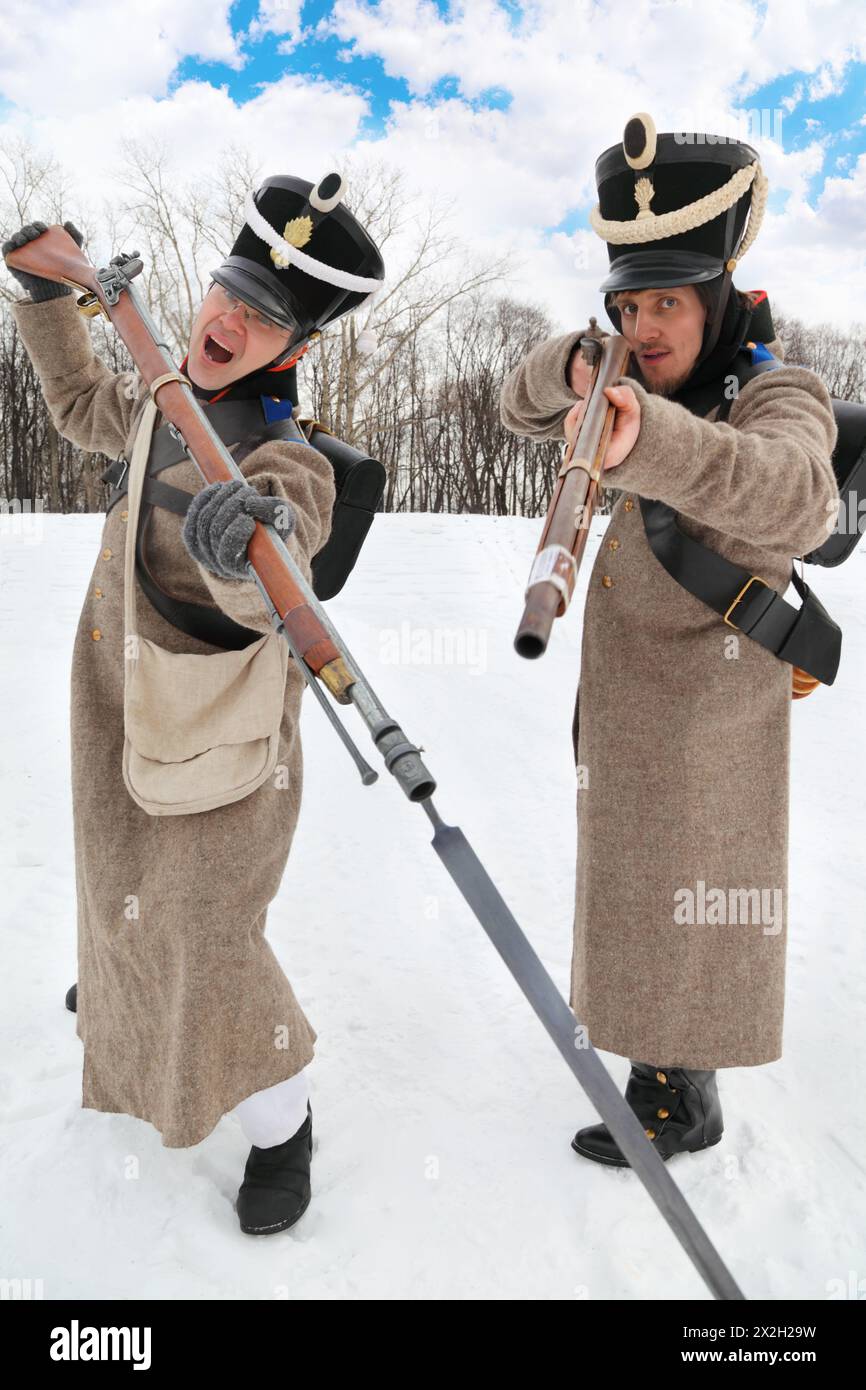 Two soldiers at historical reconstruction. one attacking by rifle ...