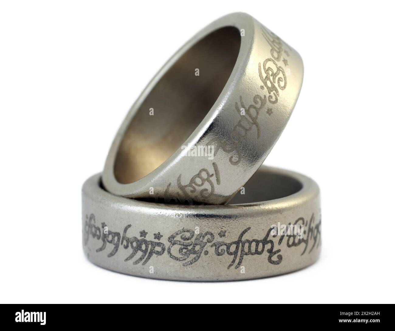 Two rings of porous silvery metal with arabic ligature isolated on ...