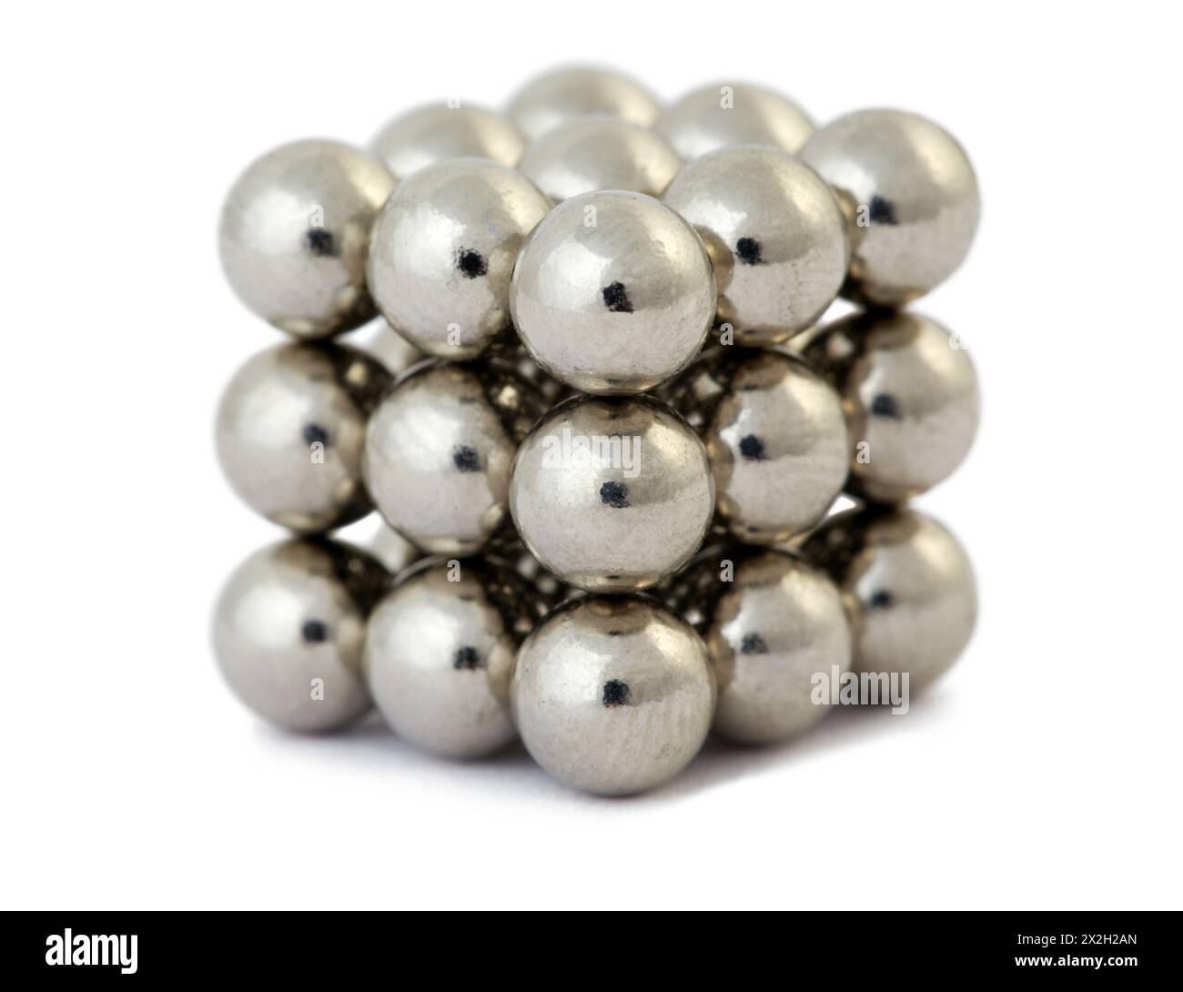Little cube assembled from little metallic magnetic balls isolated on ...