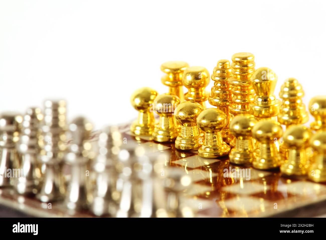 Gold and silver small chess stand on checkerboard before battle ...