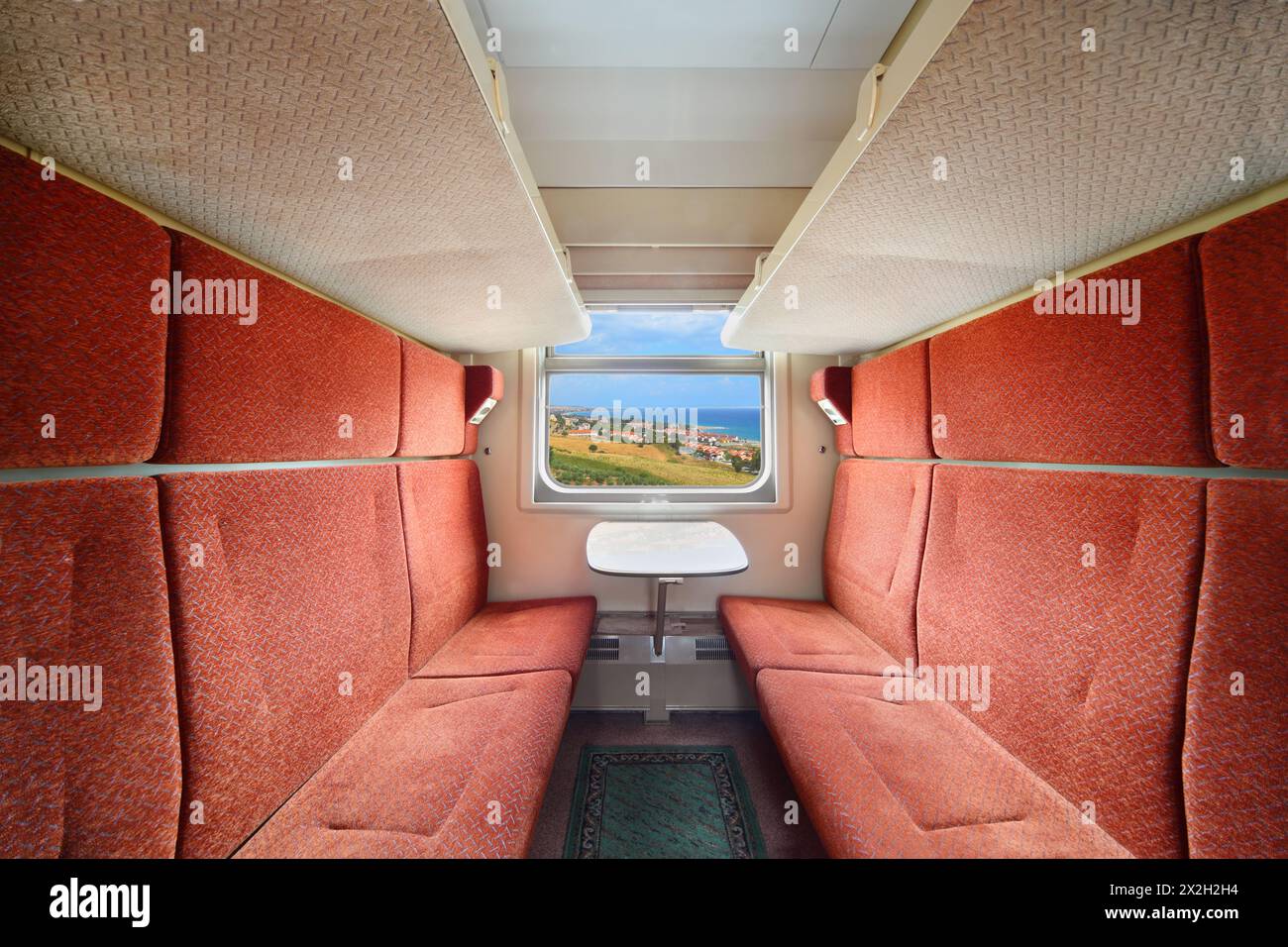 Railroad train interior. Inside of train - red seats; table and window ...
