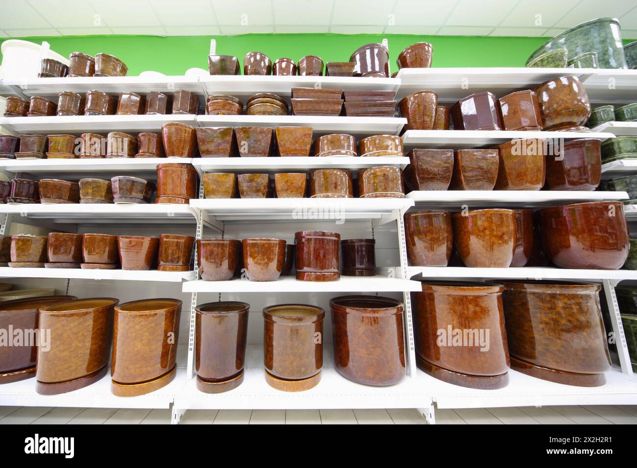 Shelves with variety of brown clay flowerpot inside large supermarket ...