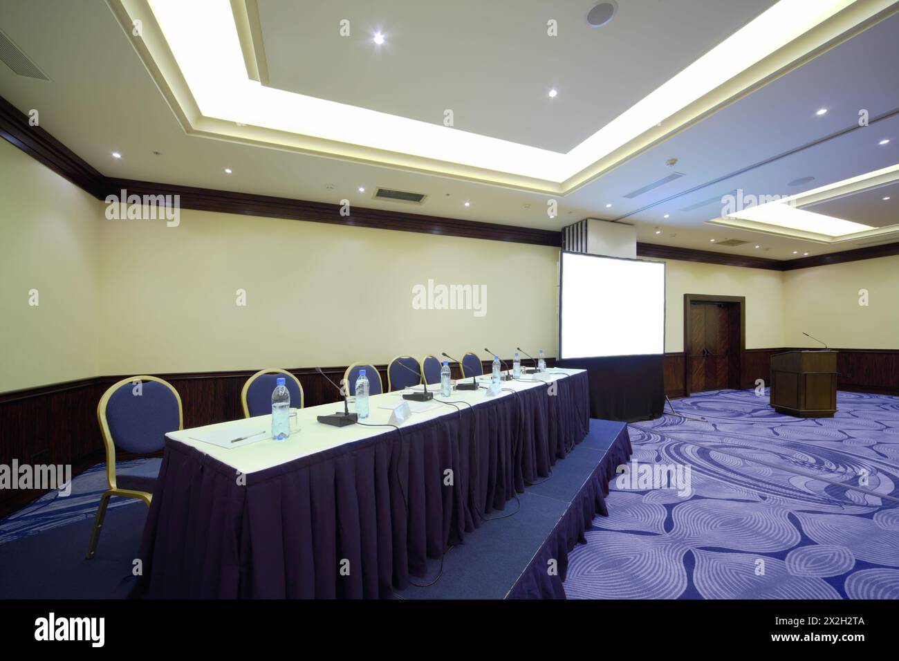 Big table with microphone near screen in bright conference hall Stock ...