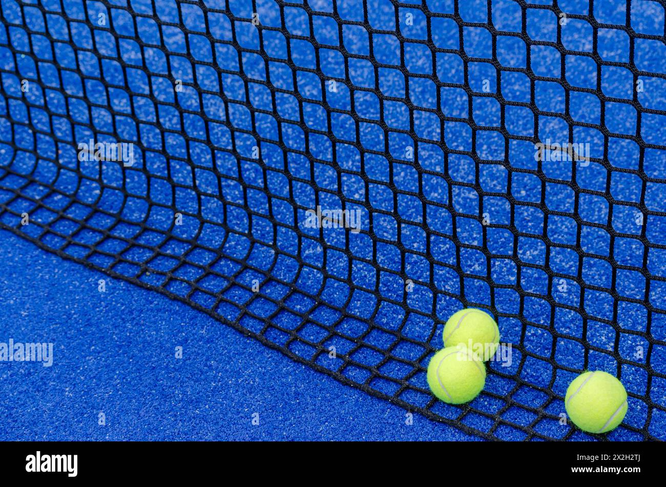 balls next to a paddle tennis court net, racket sports concept Stock ...