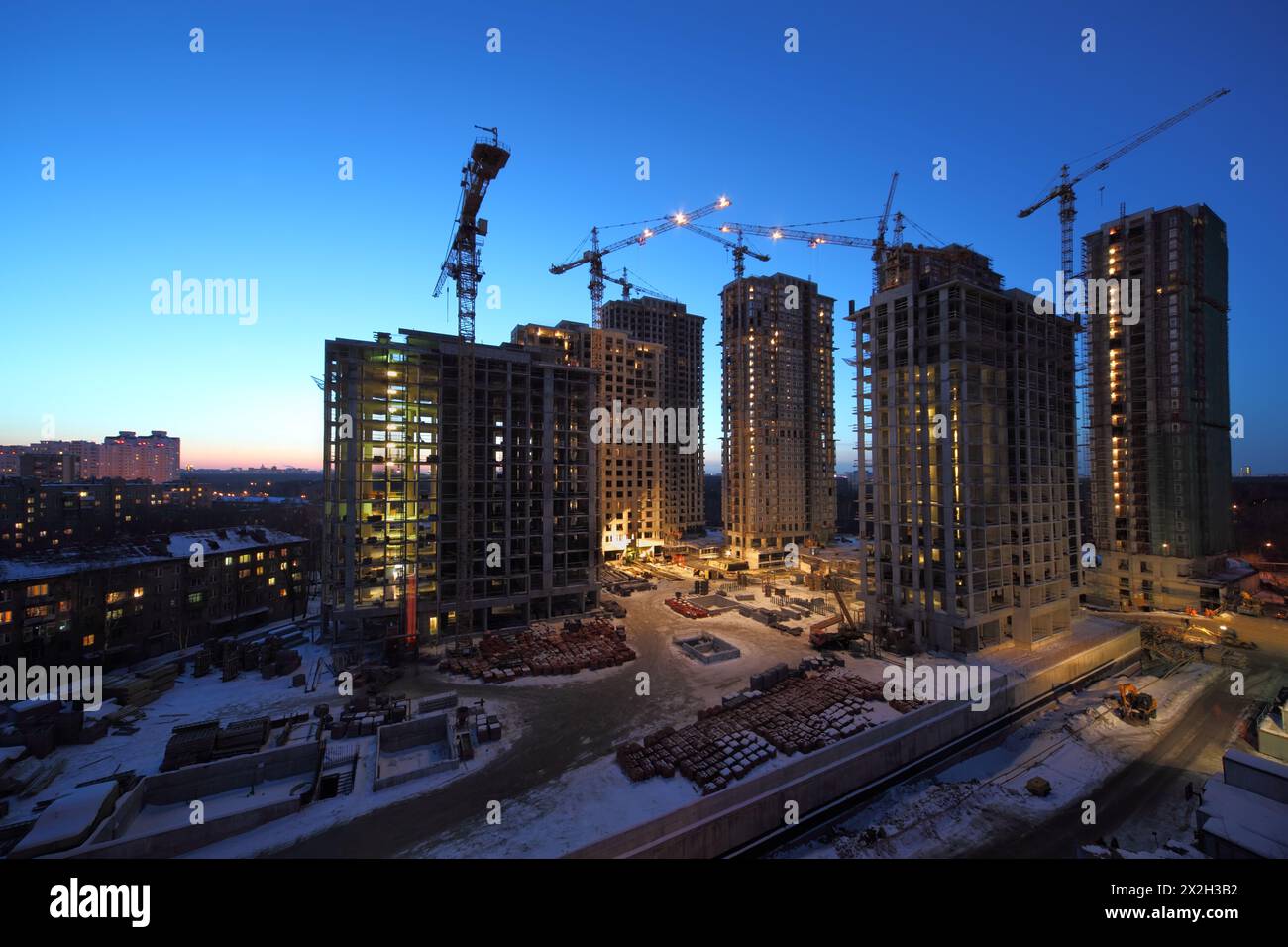 Seven high buildings under construction with cranes at evening Stock ...