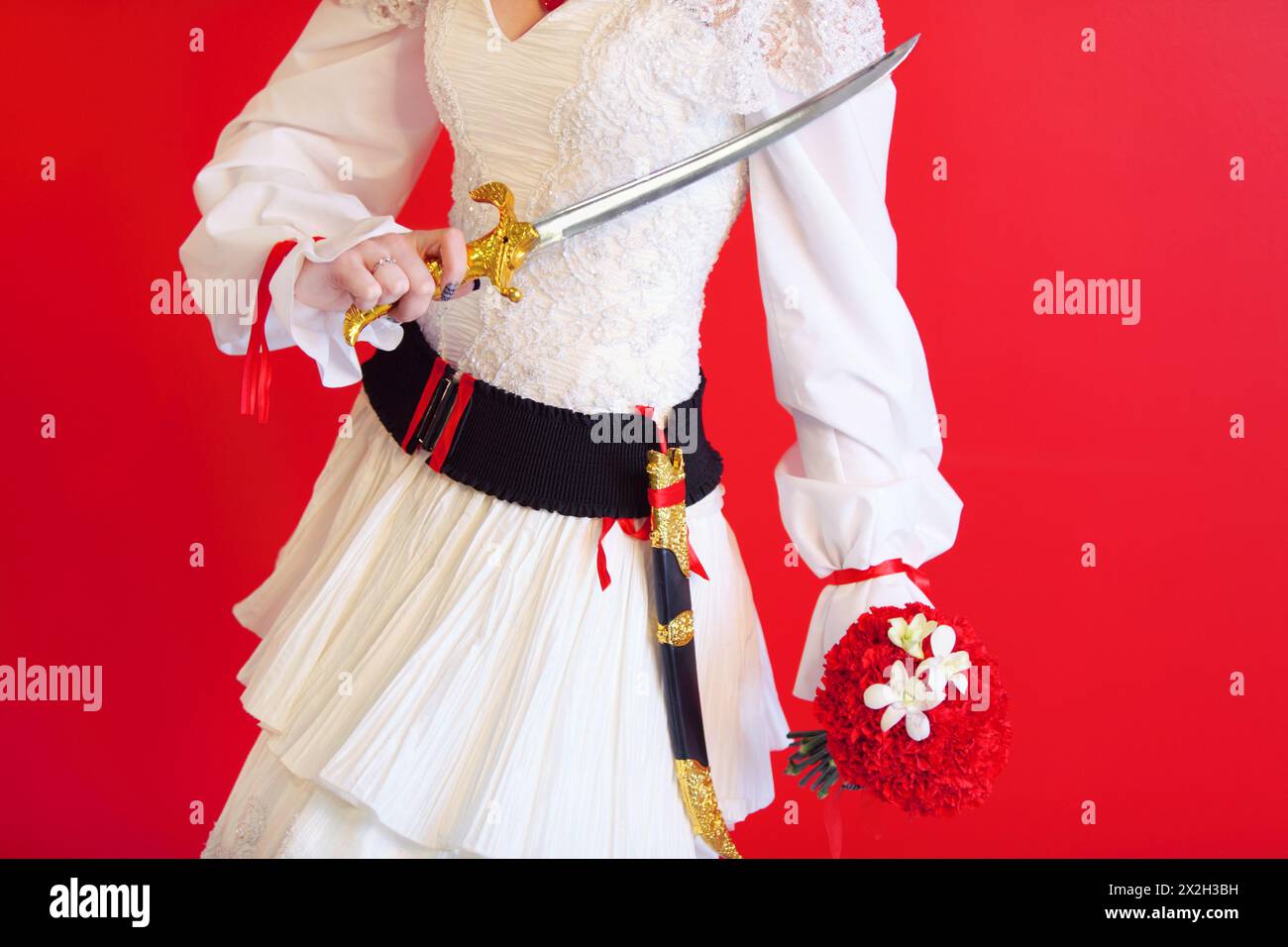 hands of bride wearing white dress with beautiful dagger and bouquet of ...