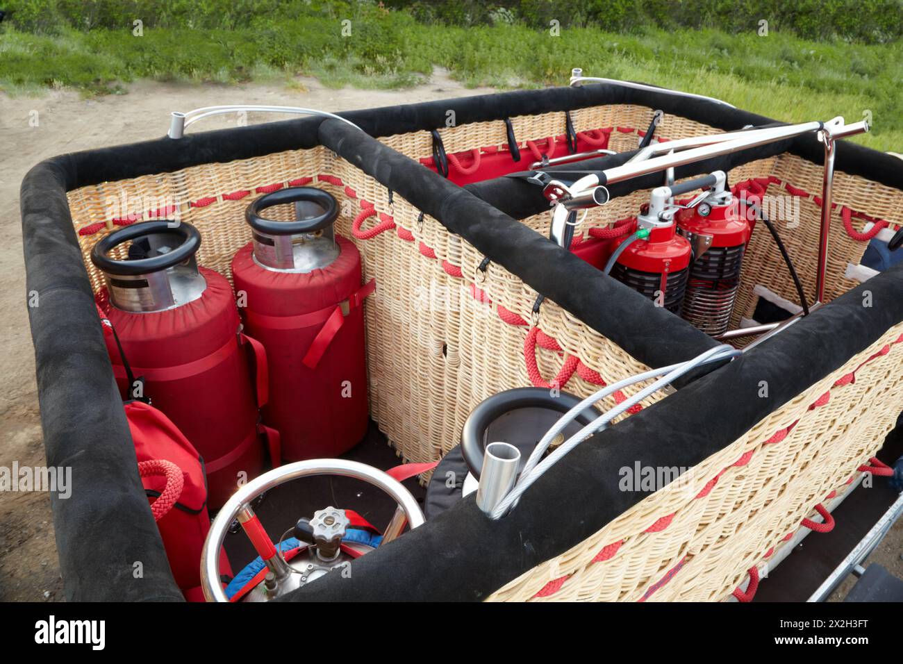 Woven basket with gas equipment for a hot air balloon stands on the ...