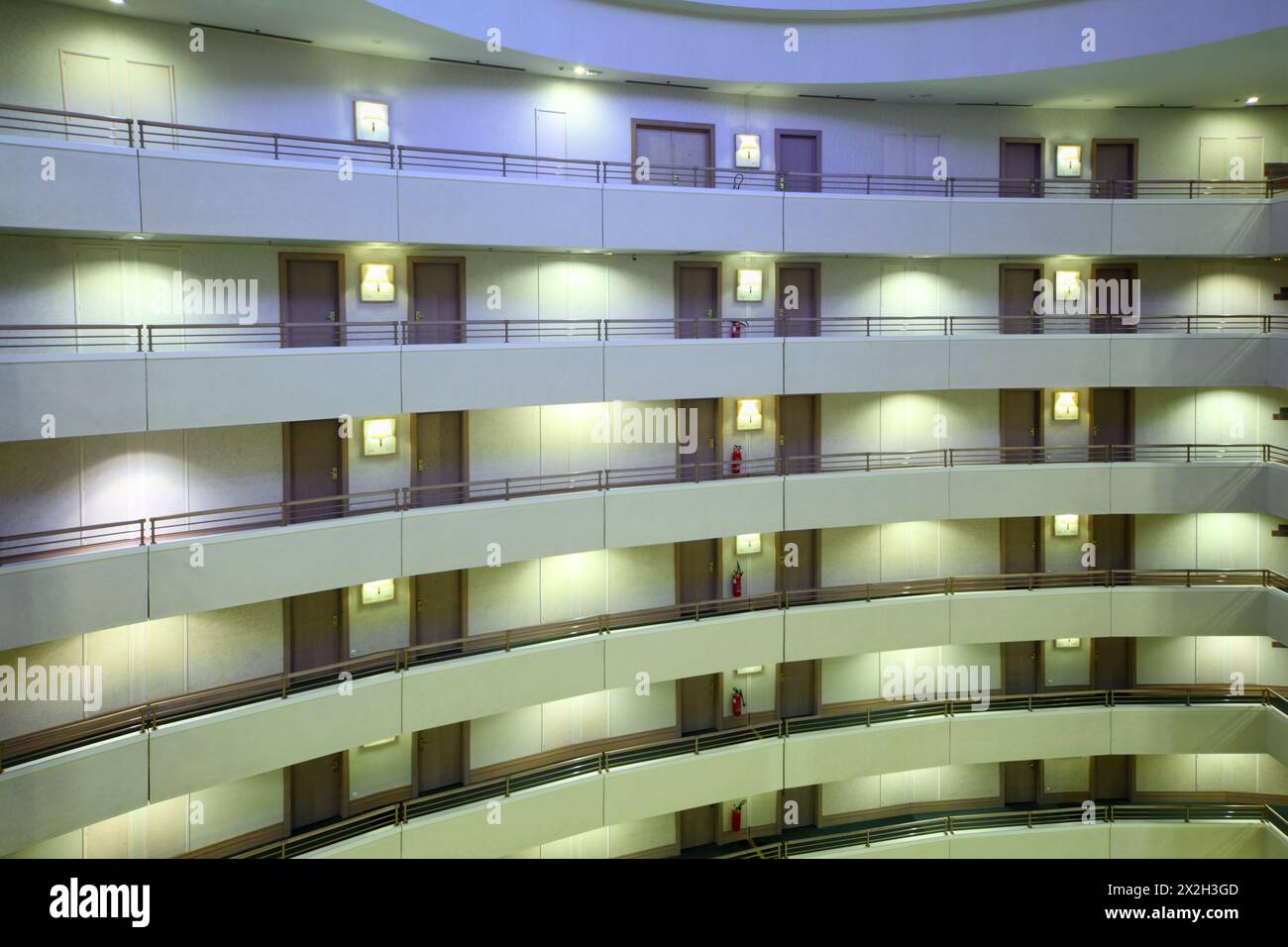 Stories in large hotel, balconies and rows of indentical doors Stock ...