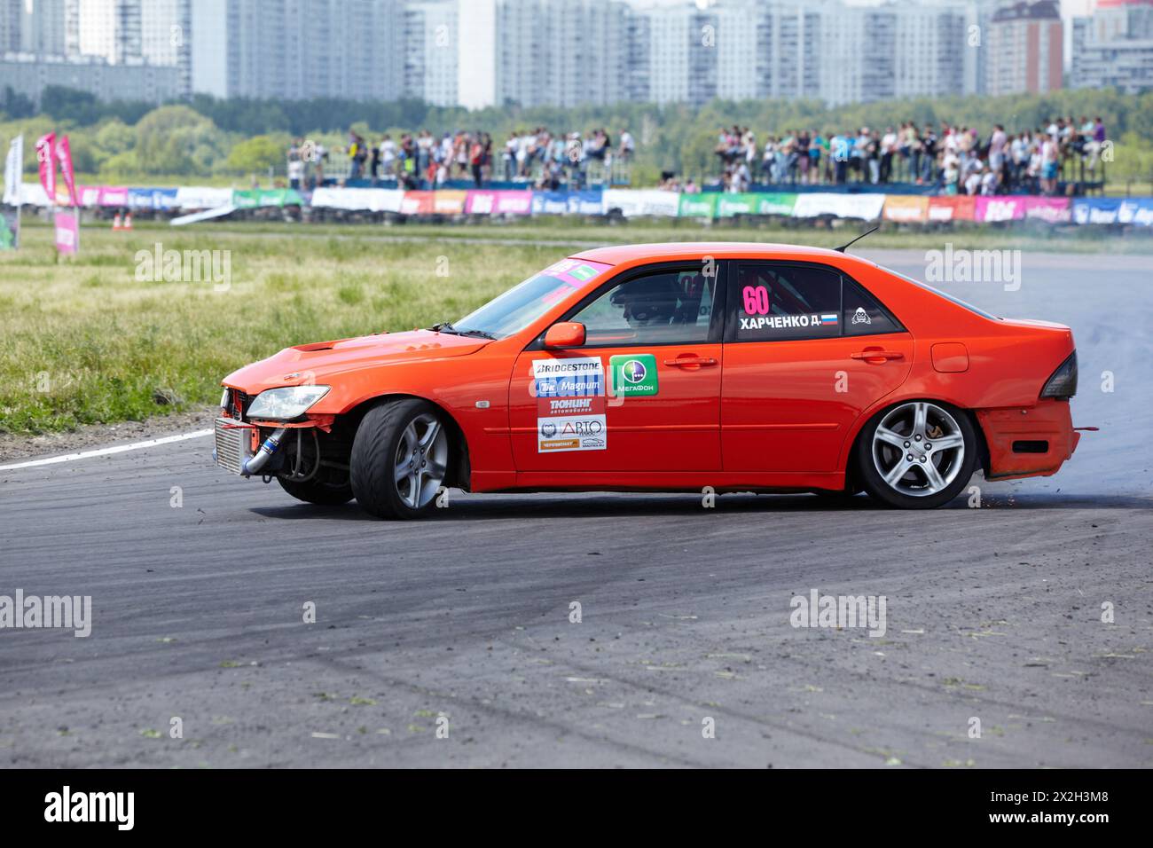 MOSCOW - JUNE 11: Red racing car with pilot D.Kharchenko rides on the ...