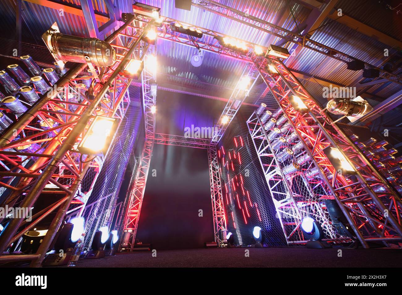 Illuminated way to boxing ring inside fight club; multi-colored lights ...
