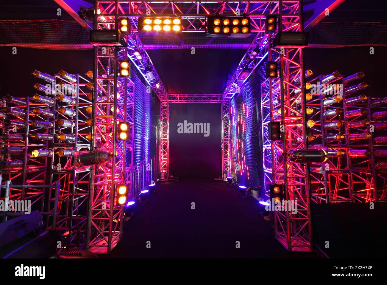 Multi-colored illuminated way with grid to boxing ring inside fight ...