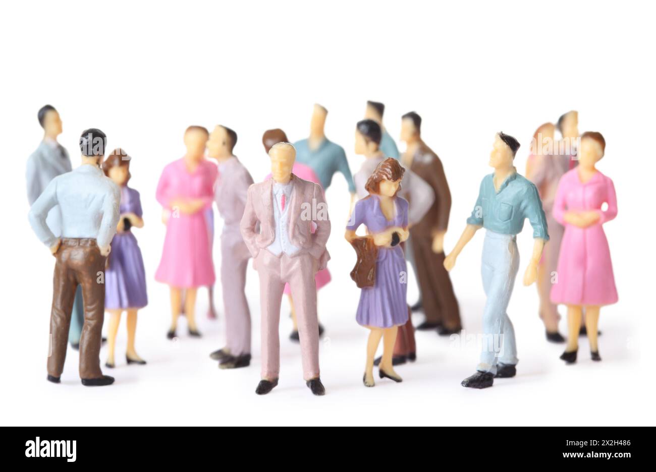 multicolored toy people stand in different poses isolated on white ...