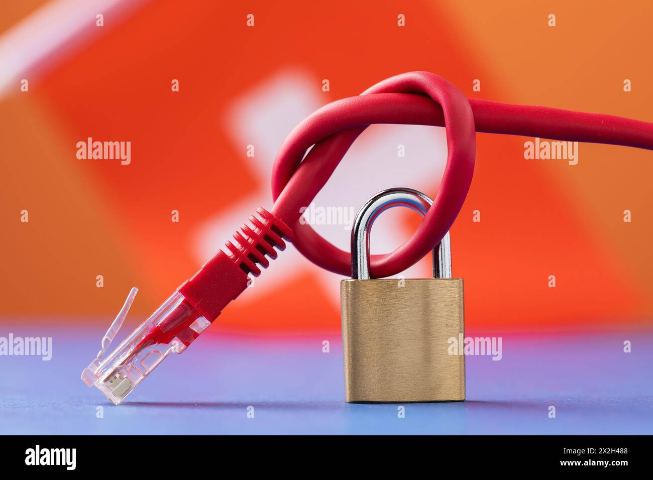 A closed lock on a tied network wire into a knot against the background ...
