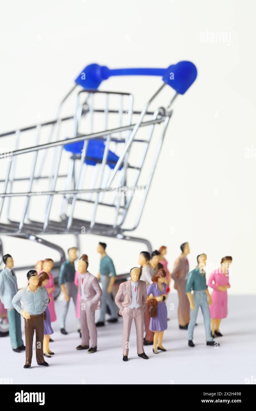 multicolored miniature toy people stand in different poses near big ...