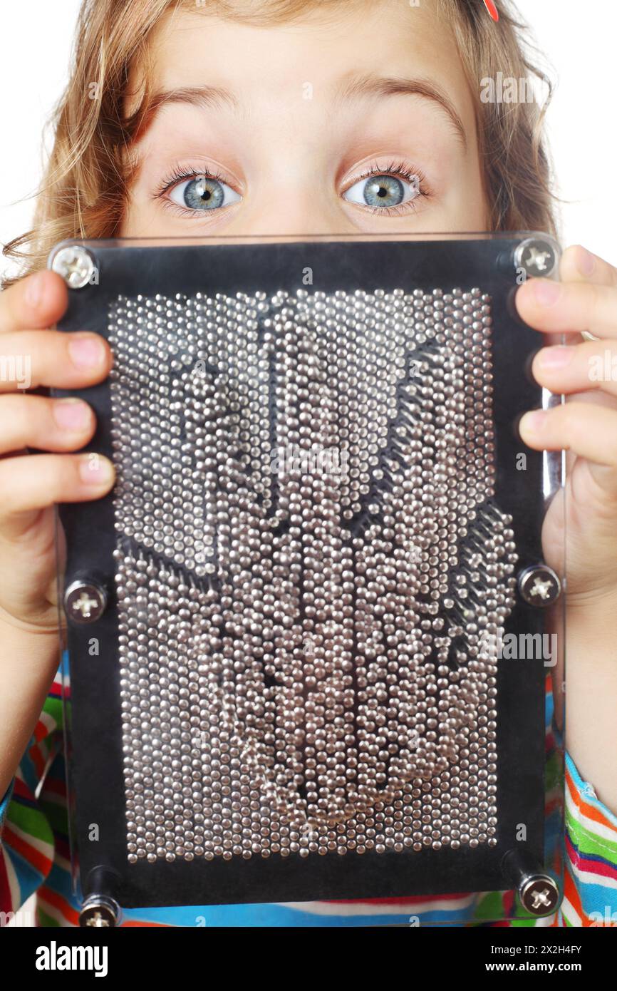 little girl hiding behind Large metal pin art pinpression toy ...