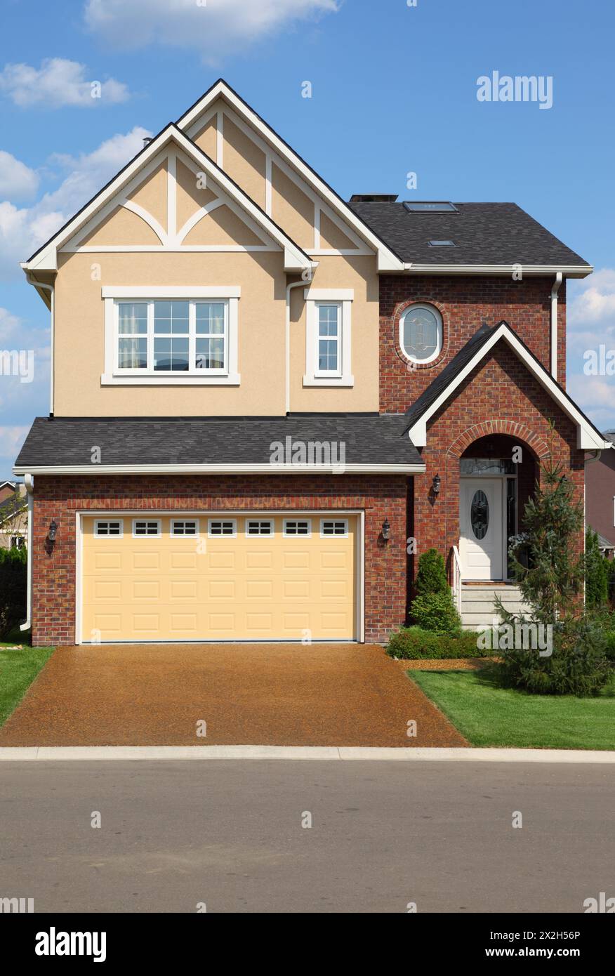 New two-storied beige brick cottage with garage on first floor Stock ...