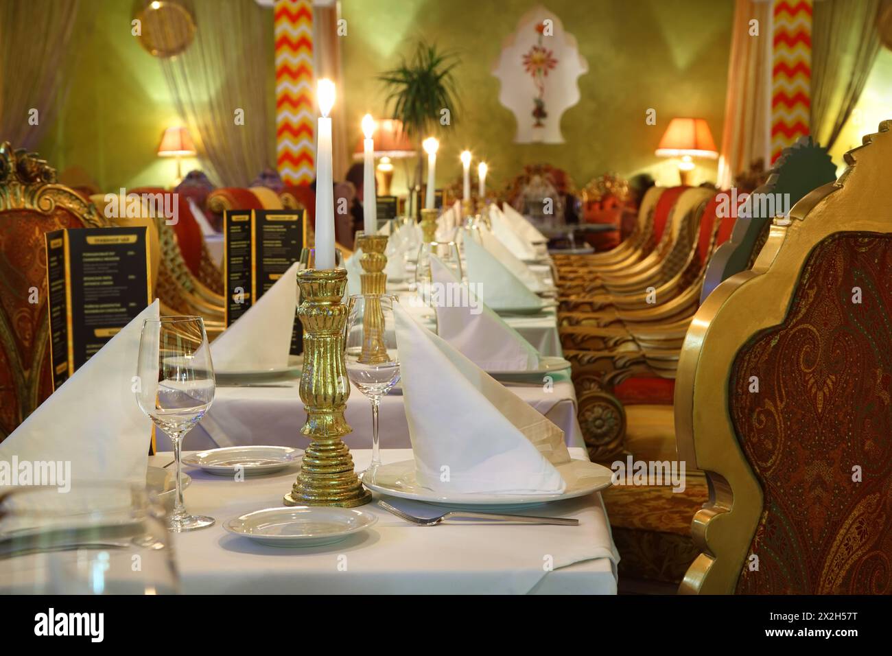 long table with serving and beautiful chairs in eastern luxury ...
