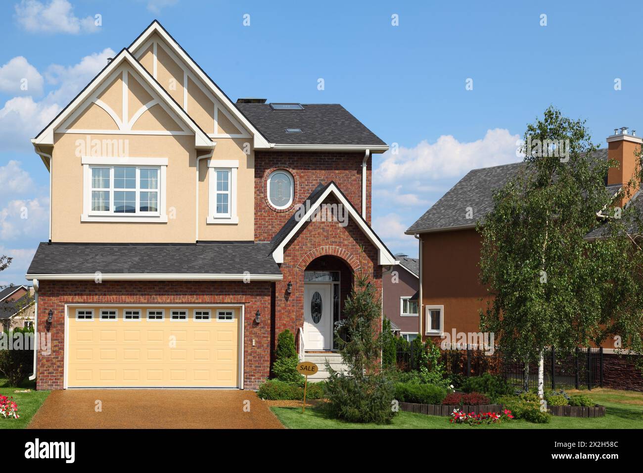 New two-storied beige cottage with green lawn in the left Stock Photo ...