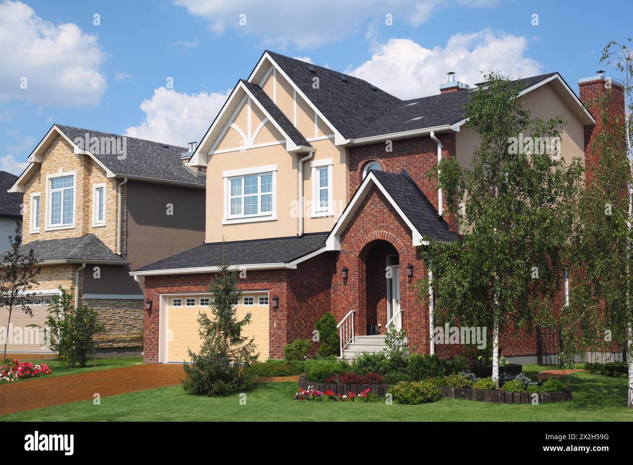 New two-storied beige brick cottage with garage at sunny day Stock ...