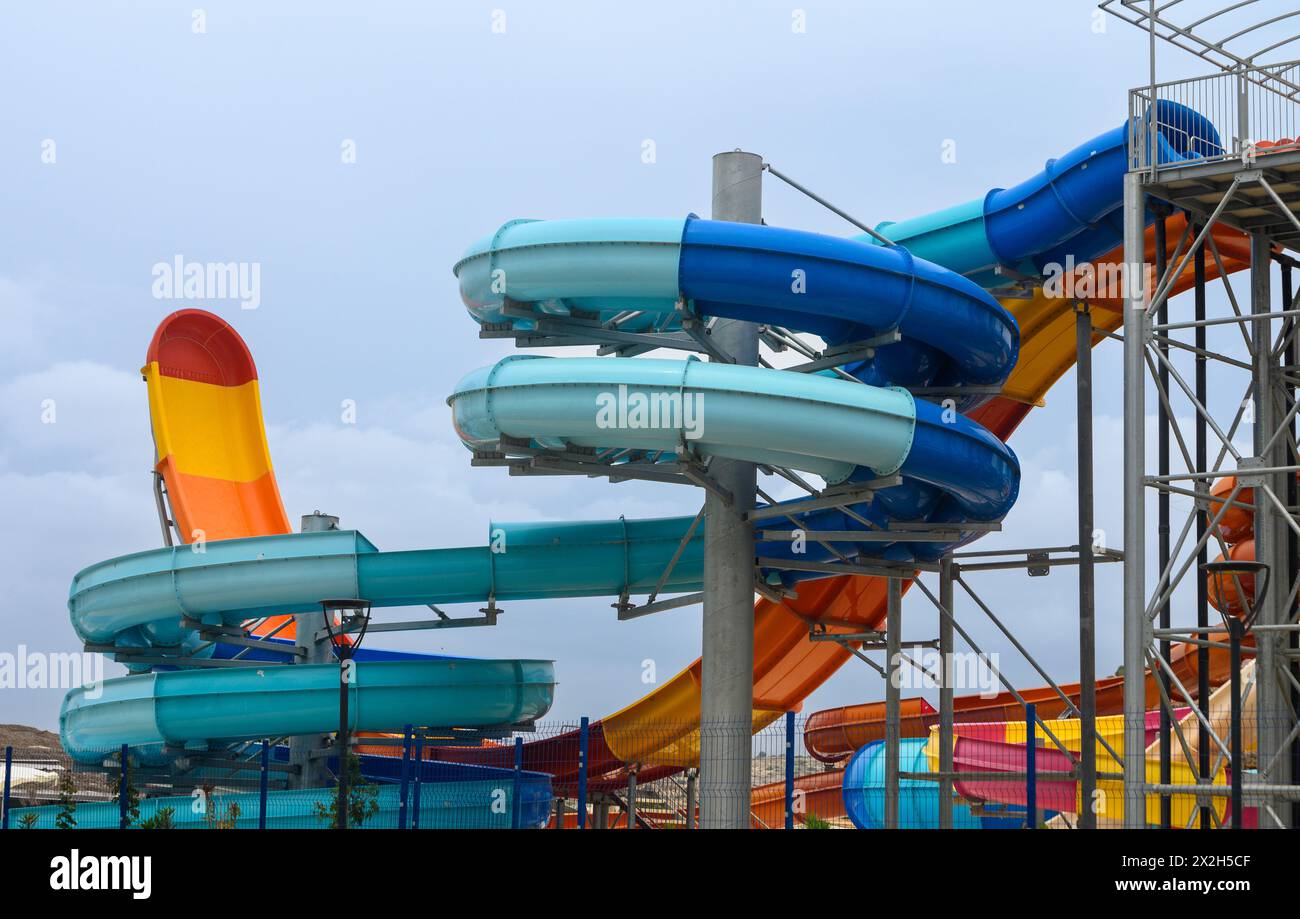 Water park, bright multi-colored slides with a pool Stock Photo - Alamy