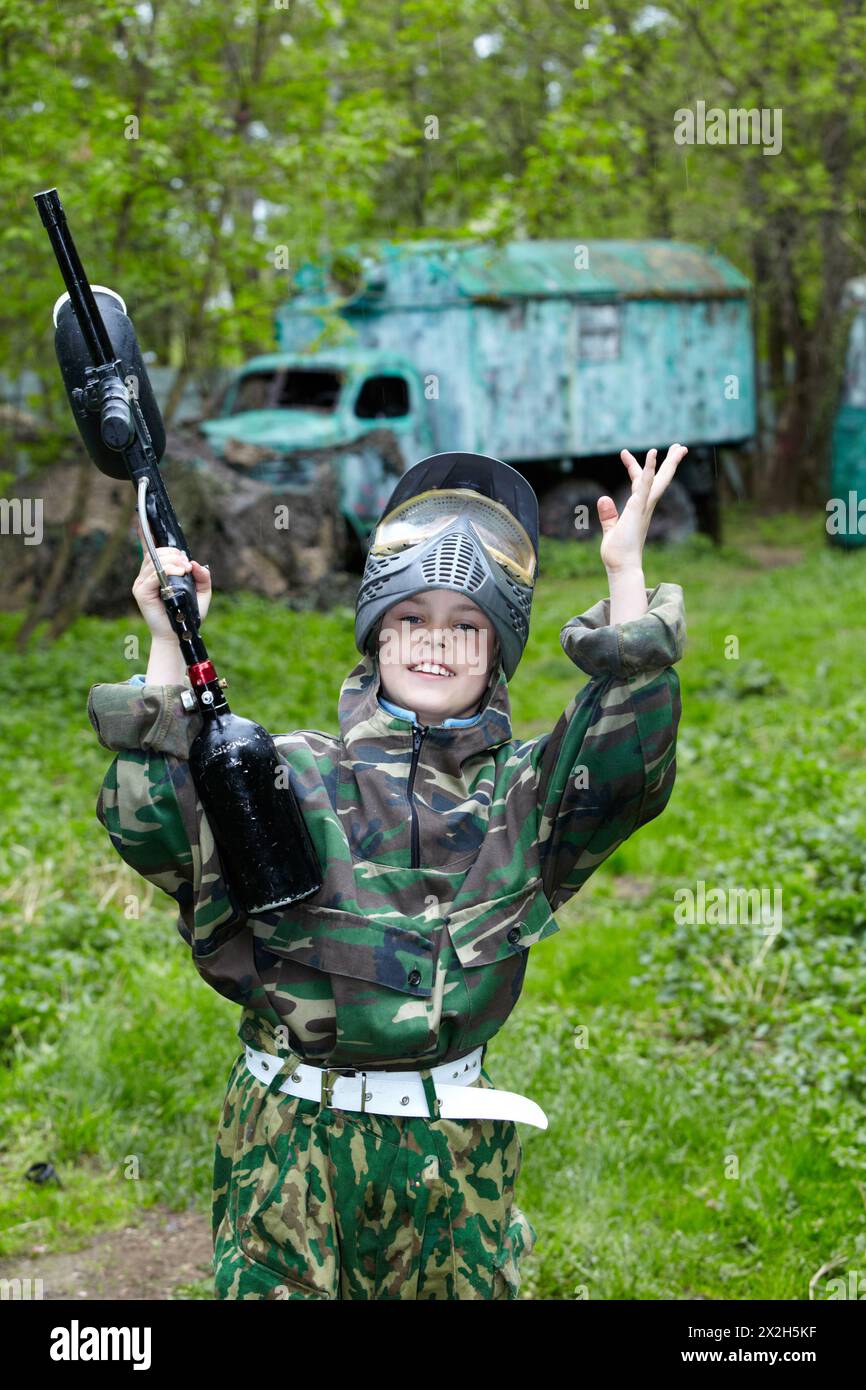 Boy in the camouflage suit, with a smile on his face triumphantly ...