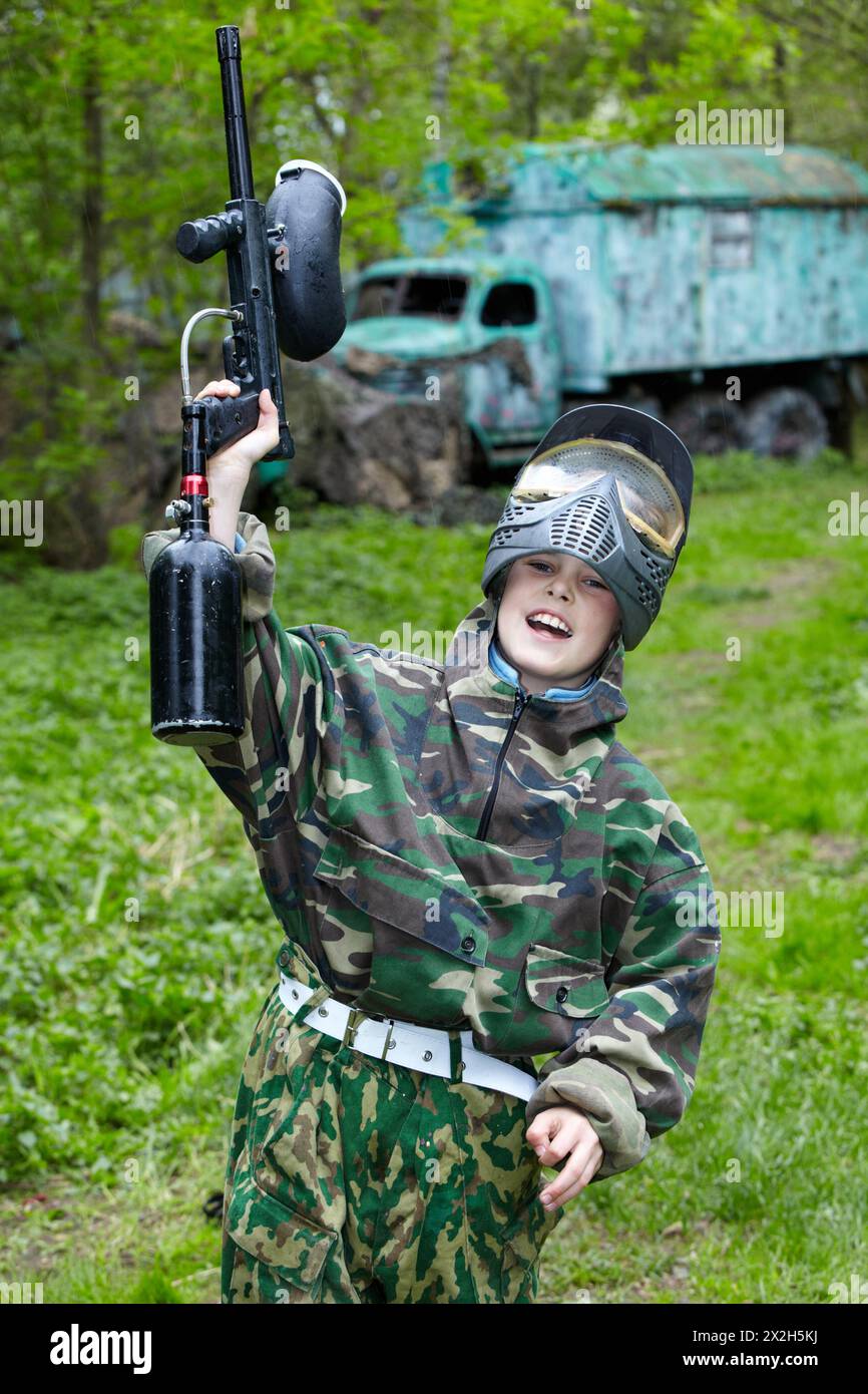 Boy in the camouflage with a smile on his face joyfully cries and ...