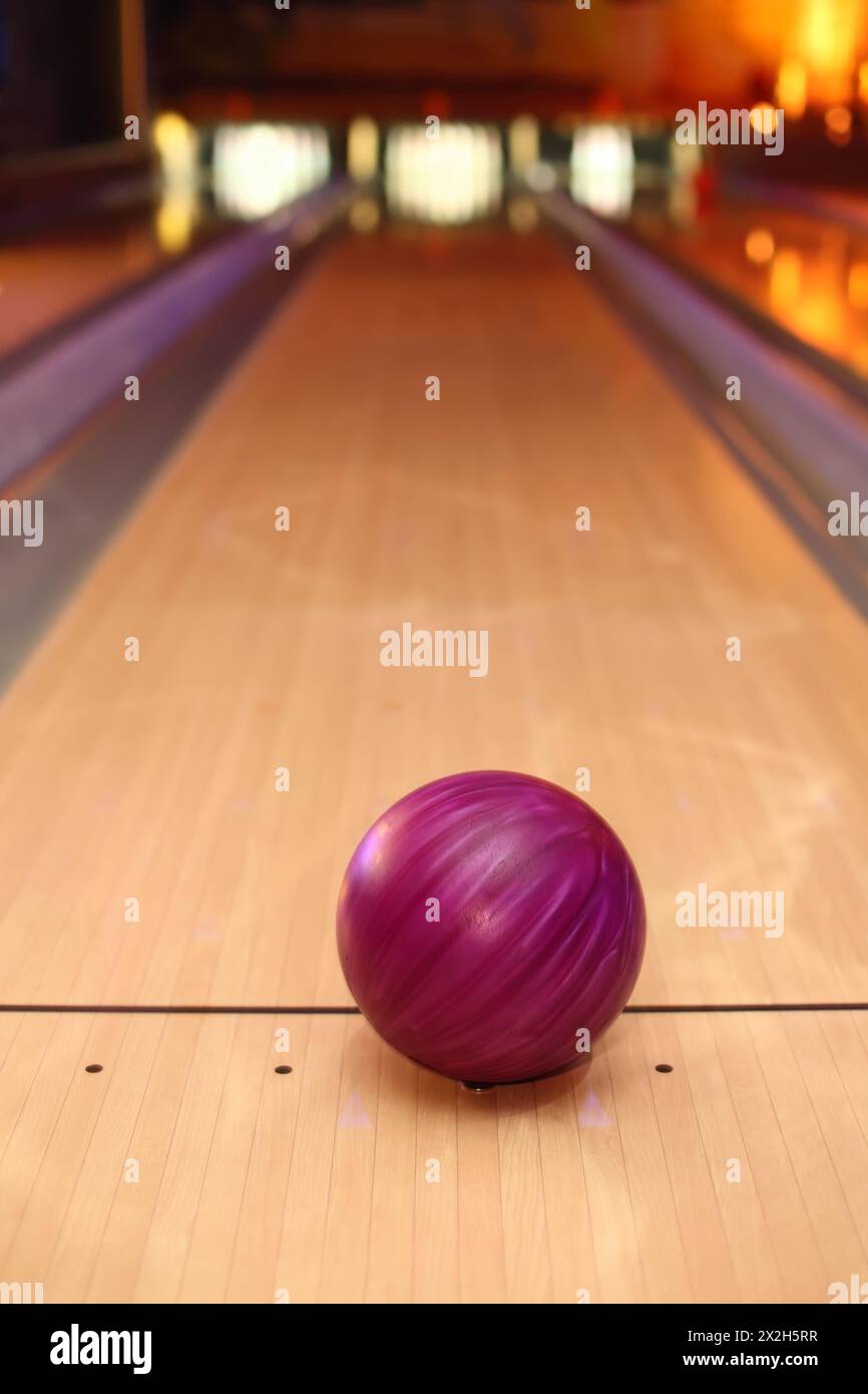 violet sphere ball standing on long bowling lane before strike Stock ...