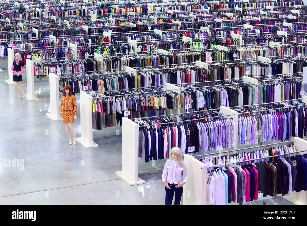 Big clothing store, dummies and many rows with hangers, variety of ...