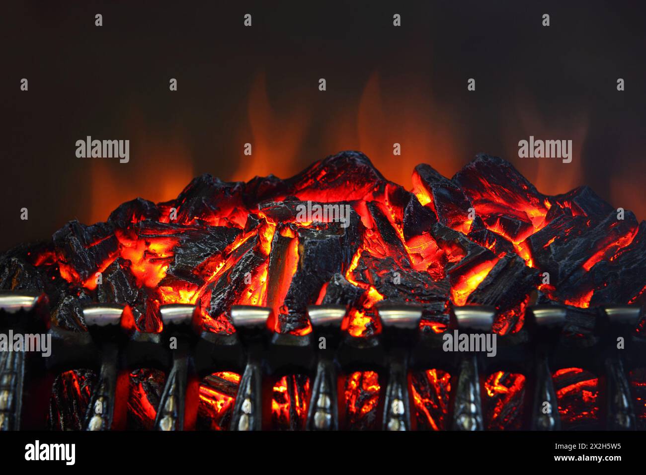 Glowing coals and fire flames in fireplace with metal grating Stock ...