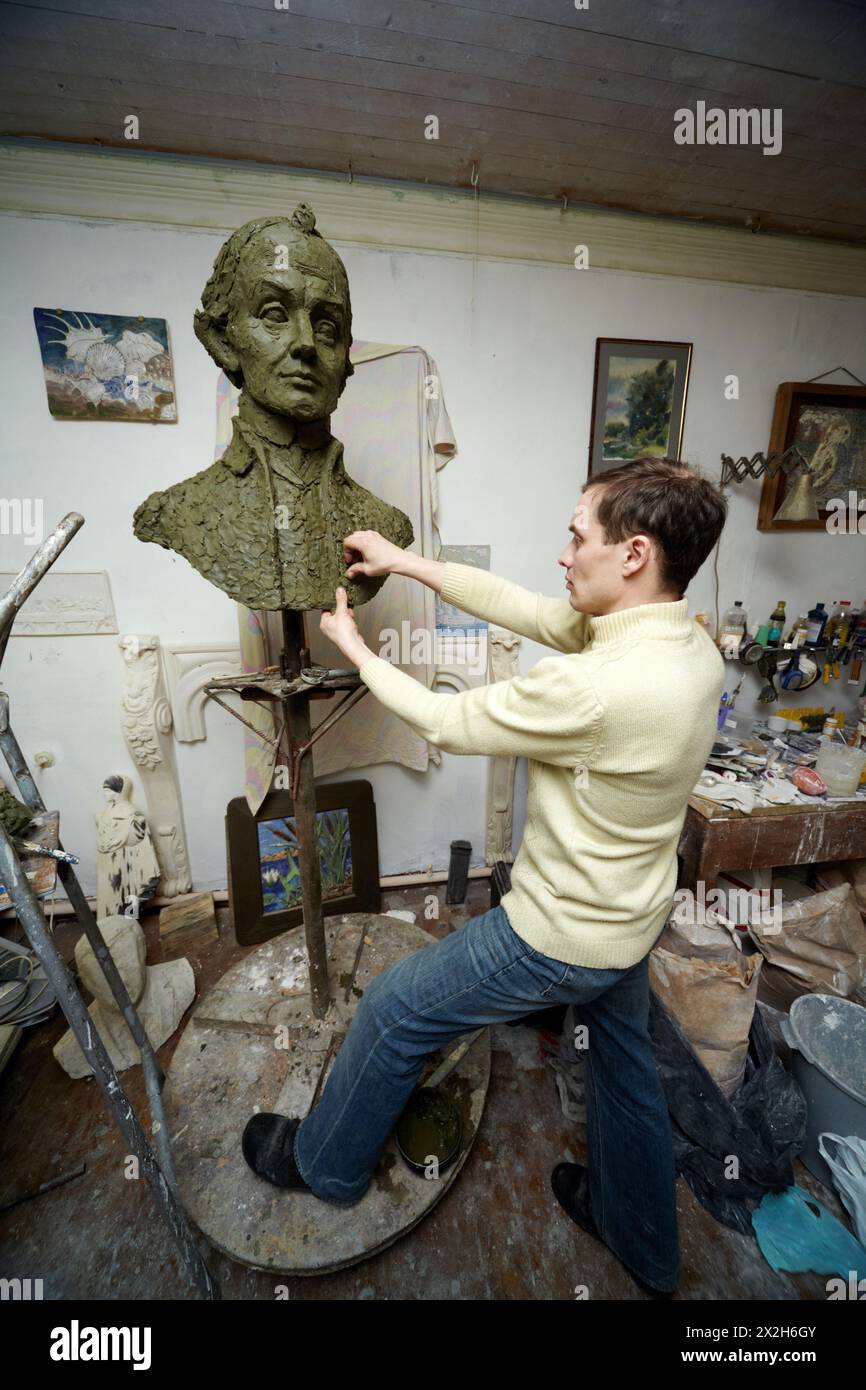 Sculptor works in the studio with a model of the bust of A.V. Suvorov ...