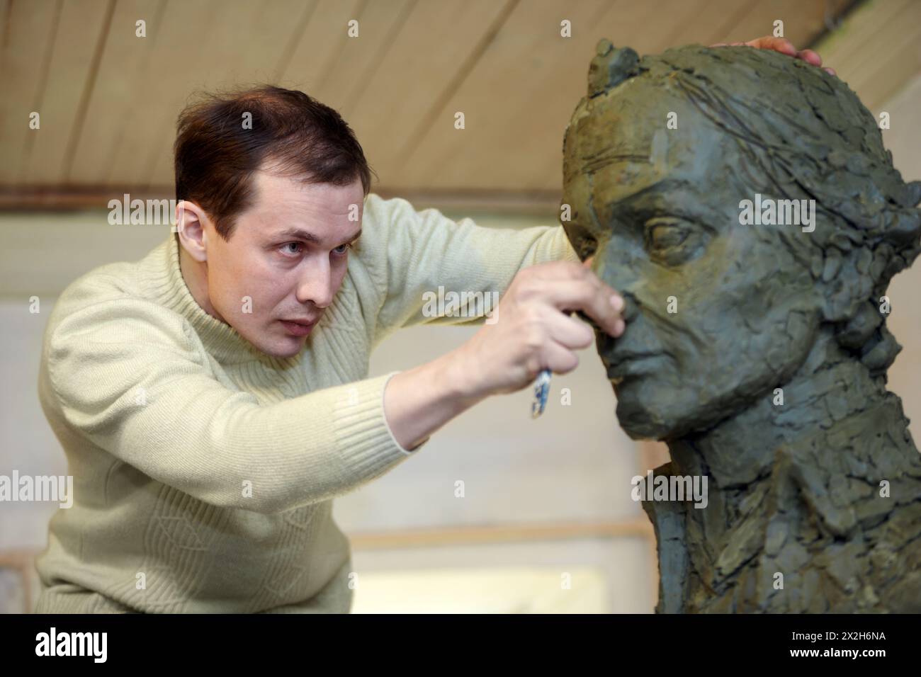 Sculptor works in the studio with a plasticine model of the bust of A.V ...