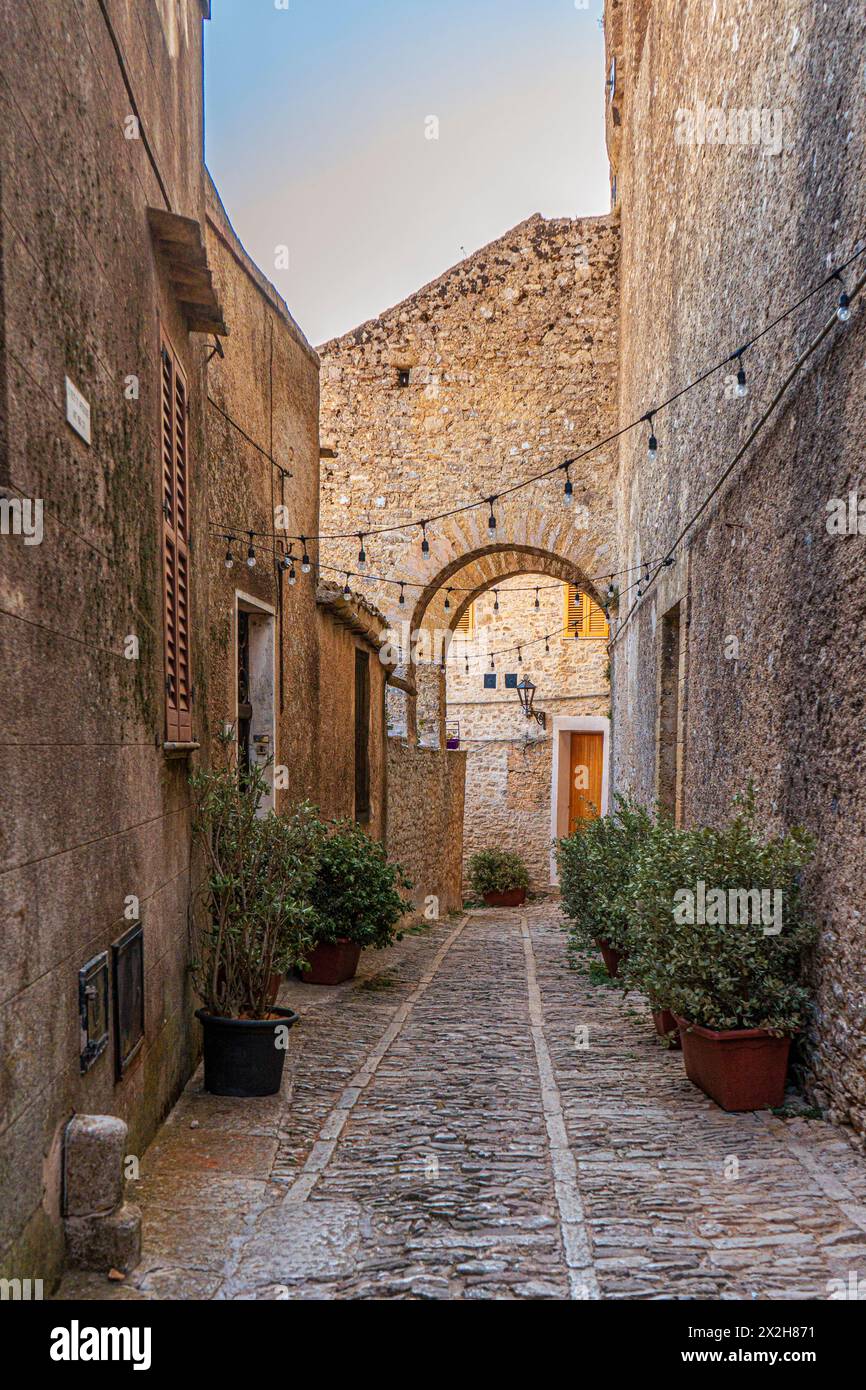 Typical narrow stone street in the medieval historical center of Erice ...
