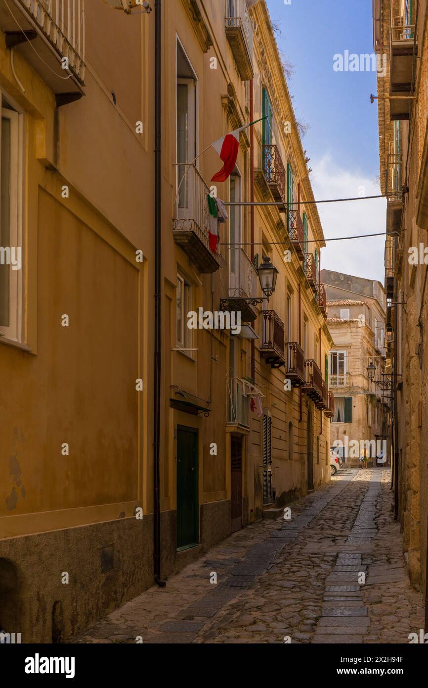 Typical narrow stone street in the historical center of Tropea in ...