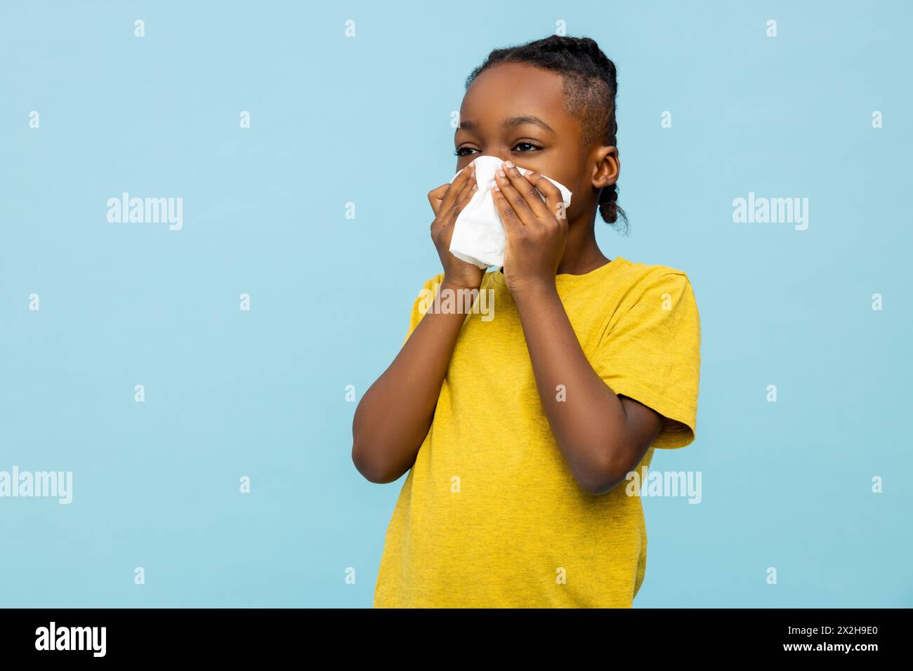 Unhealthy dark- skinned little boy suffering runny nose Stock Photo - Alamy